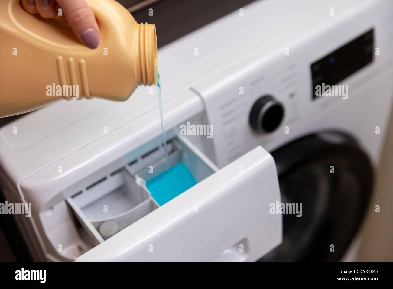 Pouring Liquid Detergent into the Washing Machine Drawer for a Fresh ...