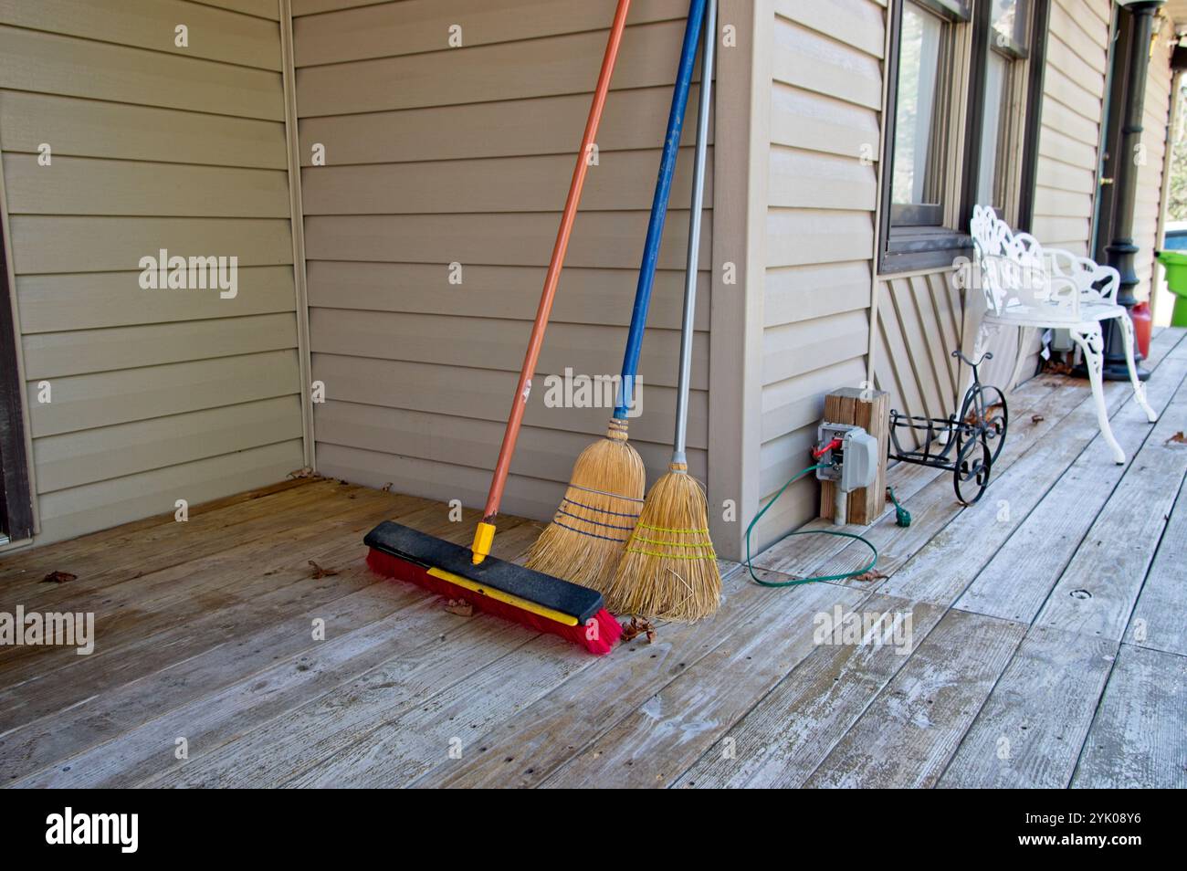 Three brooms on a wood deck Stock Photo - Alamy