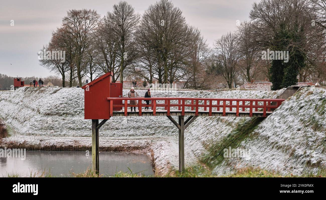 A winter view of the Bourtange fortress moat with a historic bridge to ...