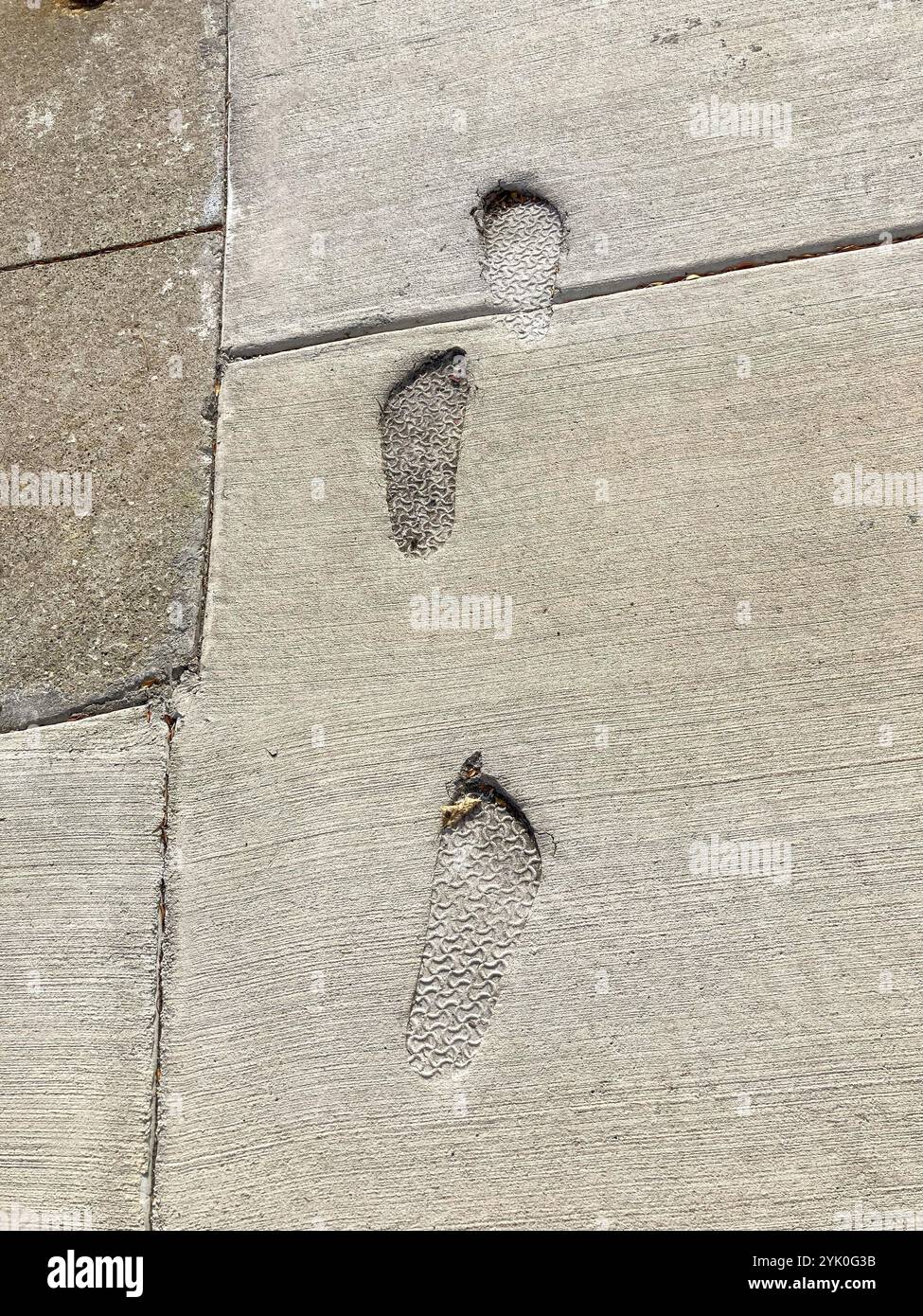 Footprints in cement sidewalk Stock Photo - Alamy