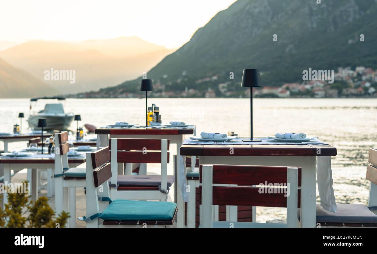 A charming waterfront dining setup with mountain views, perfect for a ...