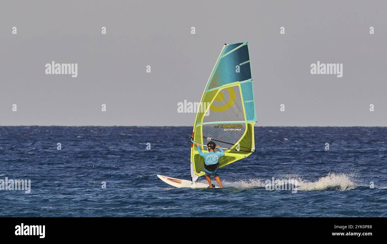Person windsurfing on calm blue sea in sunny weather, windsurfer ...