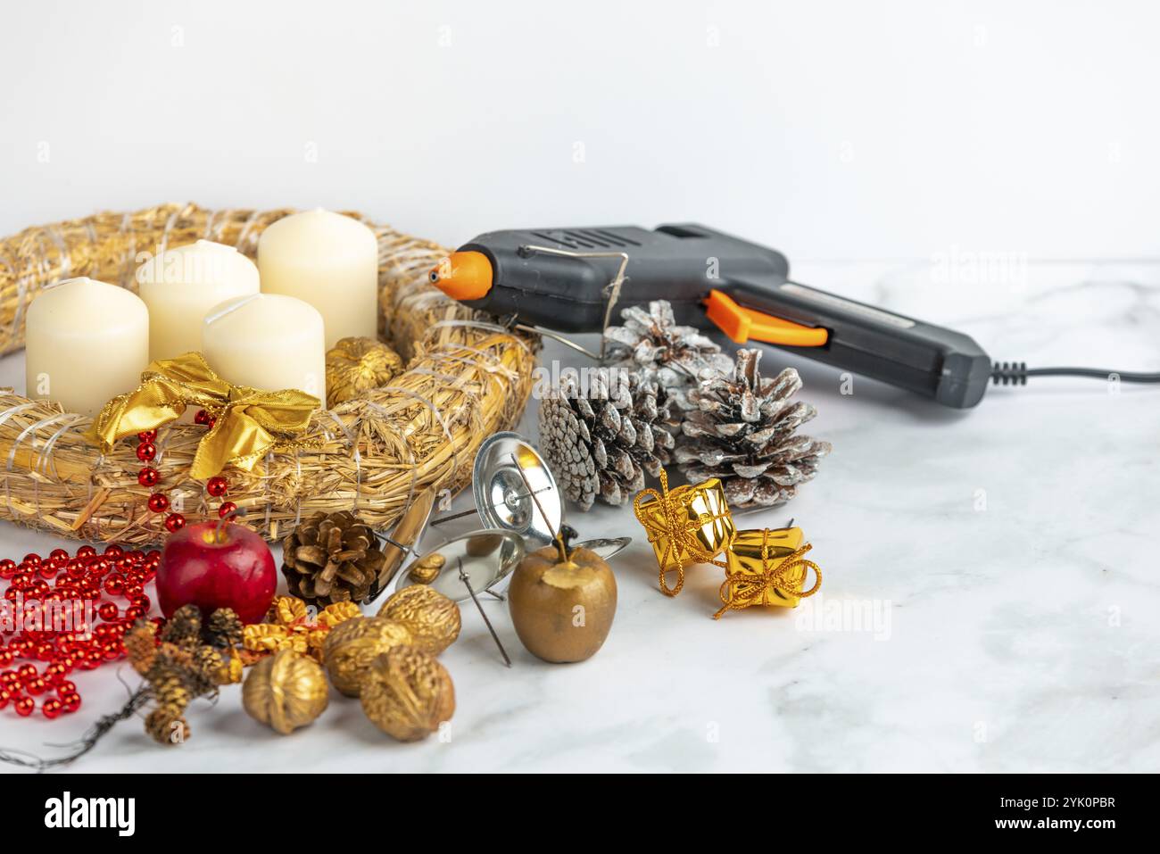 Craft scene with Advent wreath, white candles, decoration material and ...