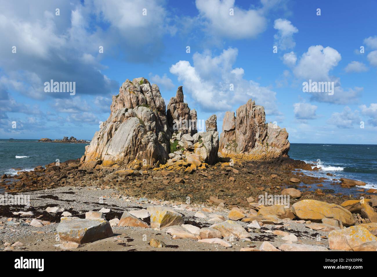 Rock formations on a sunny coast under a blue sky with clouds, Plage de ...
