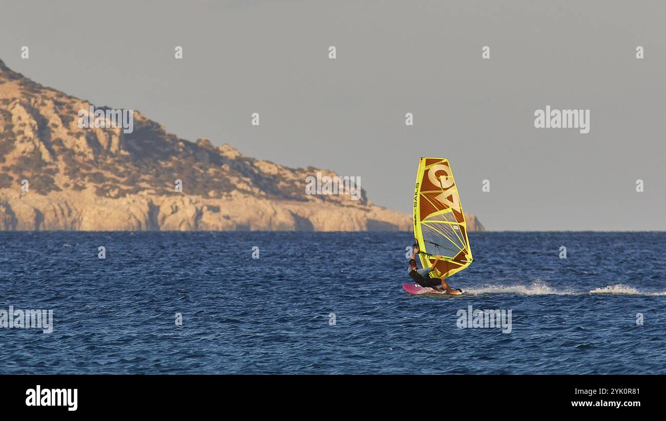 A windsurfer gliding off the coast in calm seas, windsurfer, Meltemi ...