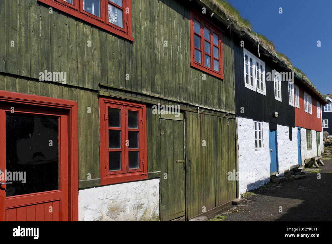 Traditional, whitewashed houses with colour-painted timber cladding and ...