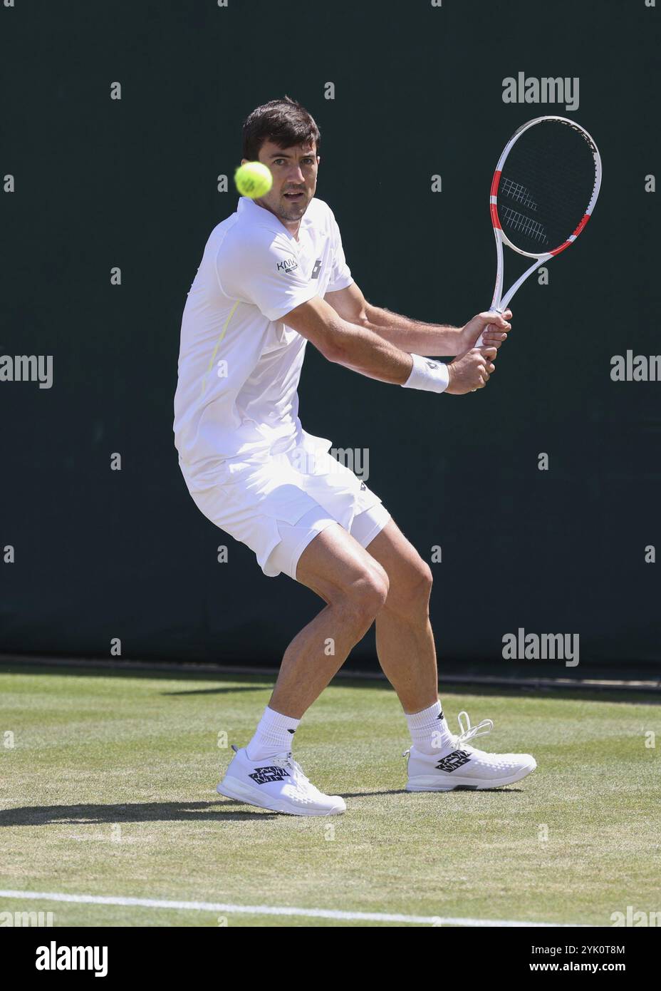 Austrian tennis player Sebastian Ofner in action at the 2024 Wimbledon ...