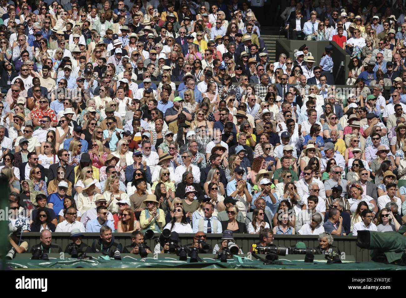 Spectators sitting in the sun on centre court at the 2024 Wimbledon ...