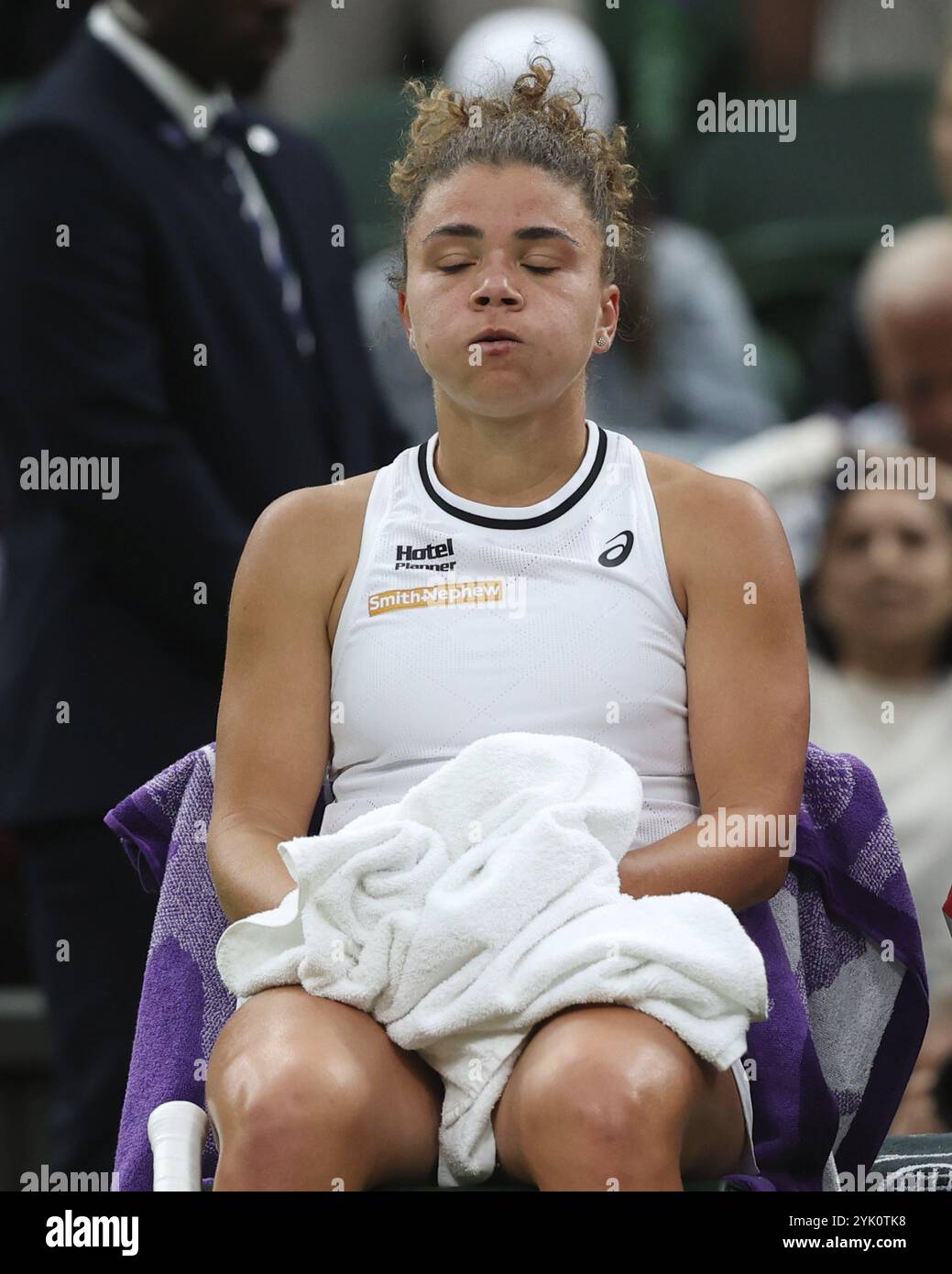 Italian tennis player Jasmine Paolini sitting down during a break and ...