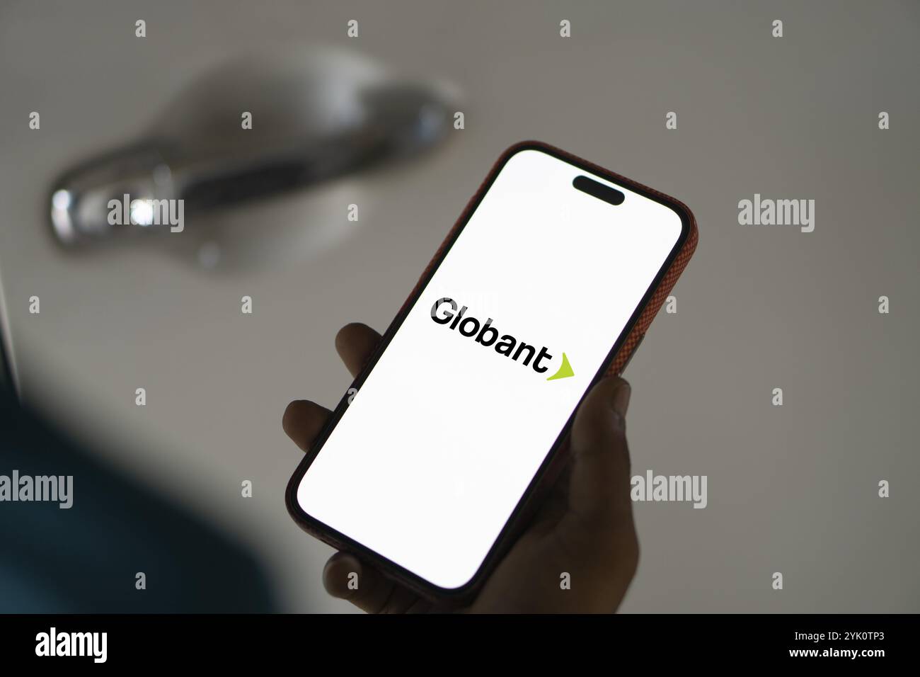 Globant logo is displayed on smartphone. Globant is an IT and software ...
