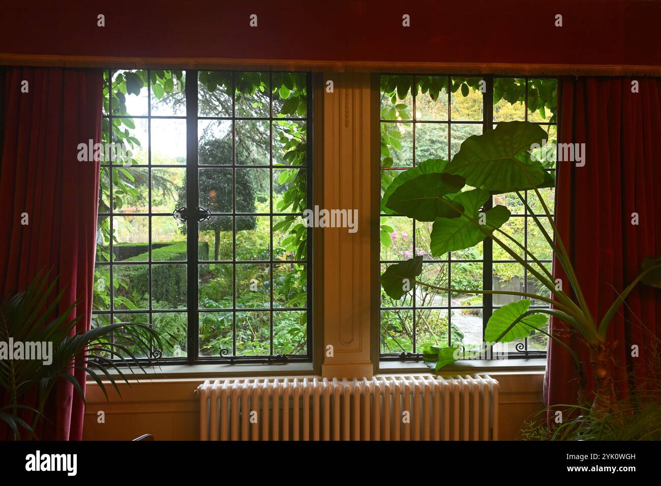 View of garden through a window at Hidcote manor house Stock Photo - Alamy