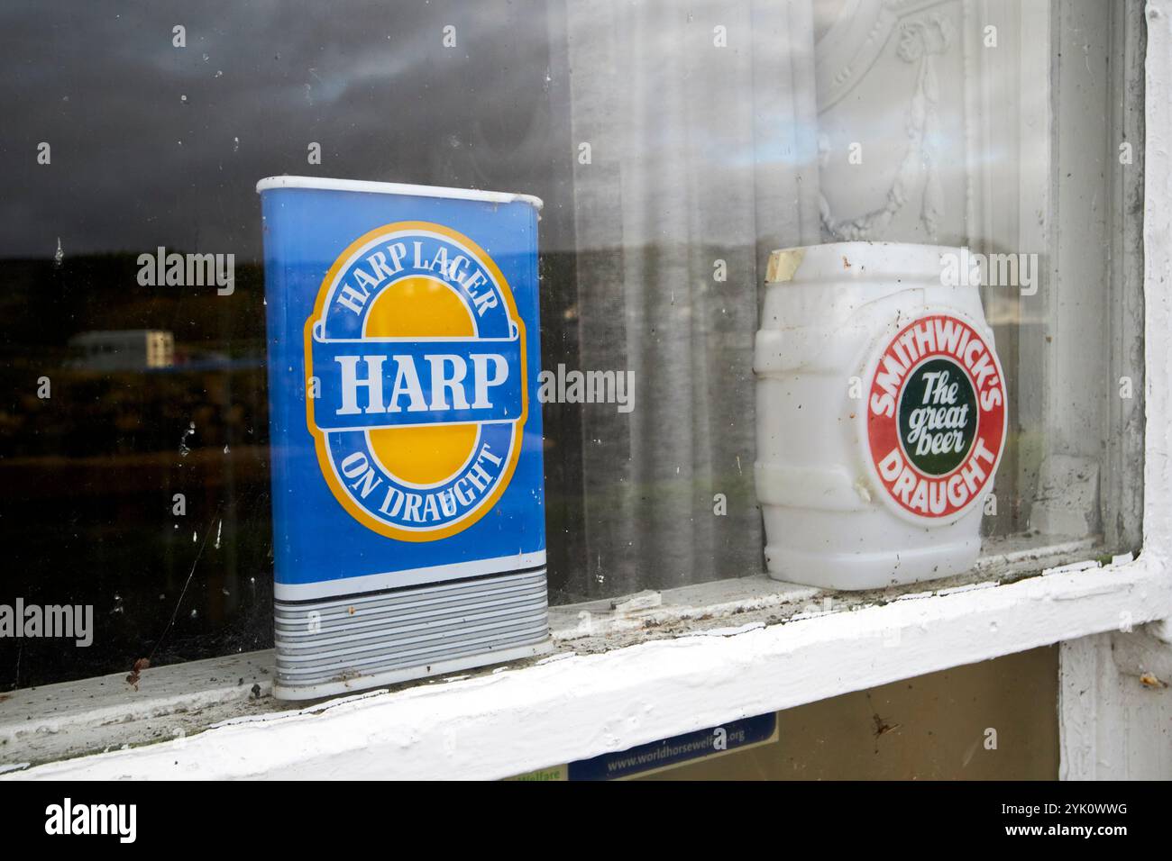 old harp lager and smithwicks draft beer signs in the window of the old ...