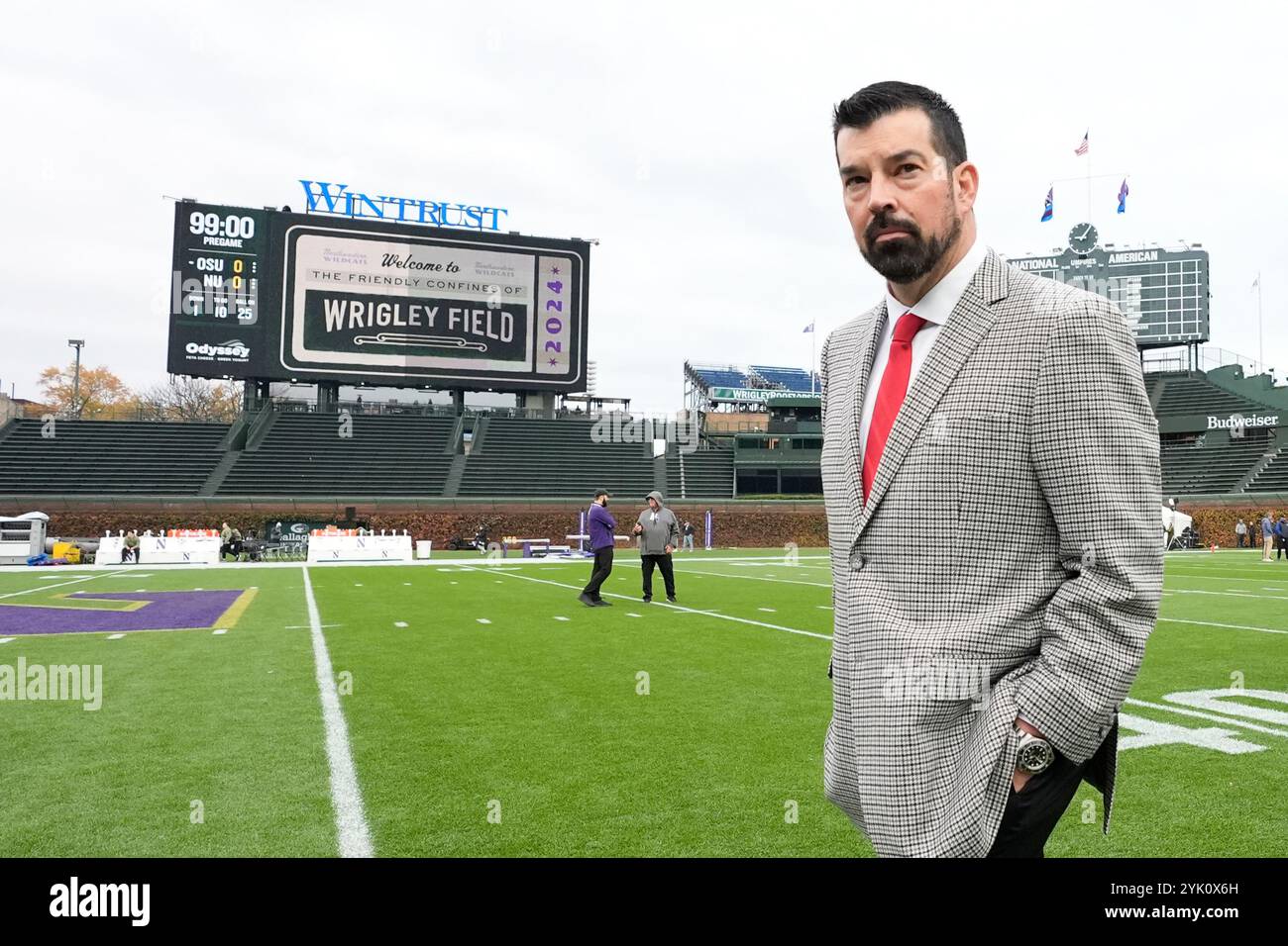 Ohio State head coach Ryan Day walks across Wrigley Field as his team ...