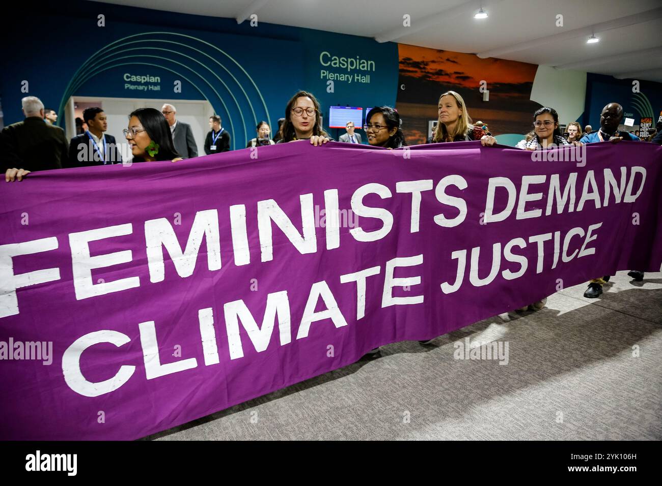 Climate activists hold a banner during a protest to influence decisions ...