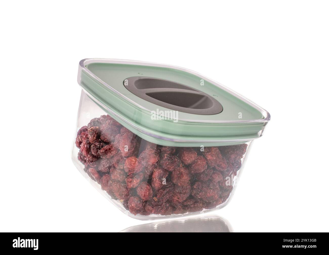 Dried cranberries with plastic container on white background, macro ...