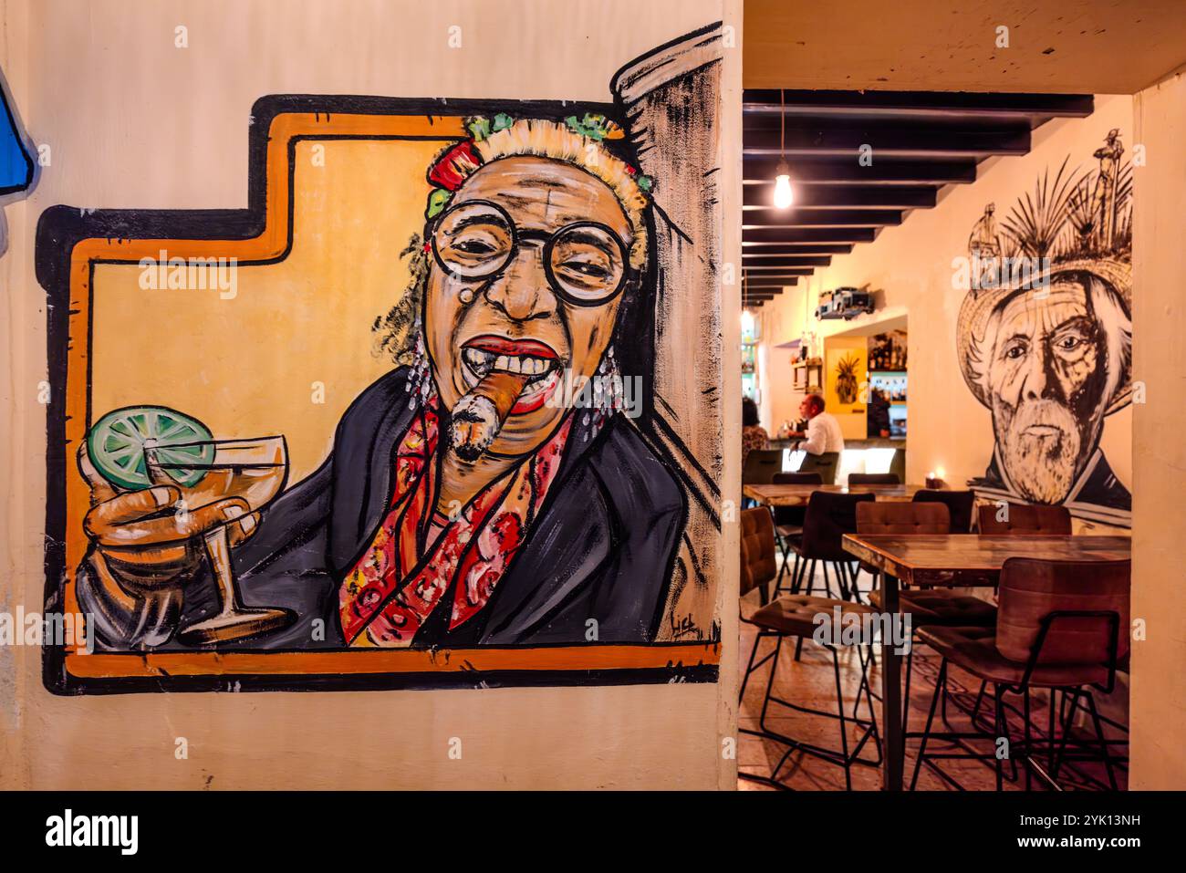 A vibrant mural adorns the wall of the MosaCaña Bar, showcasing a ...
