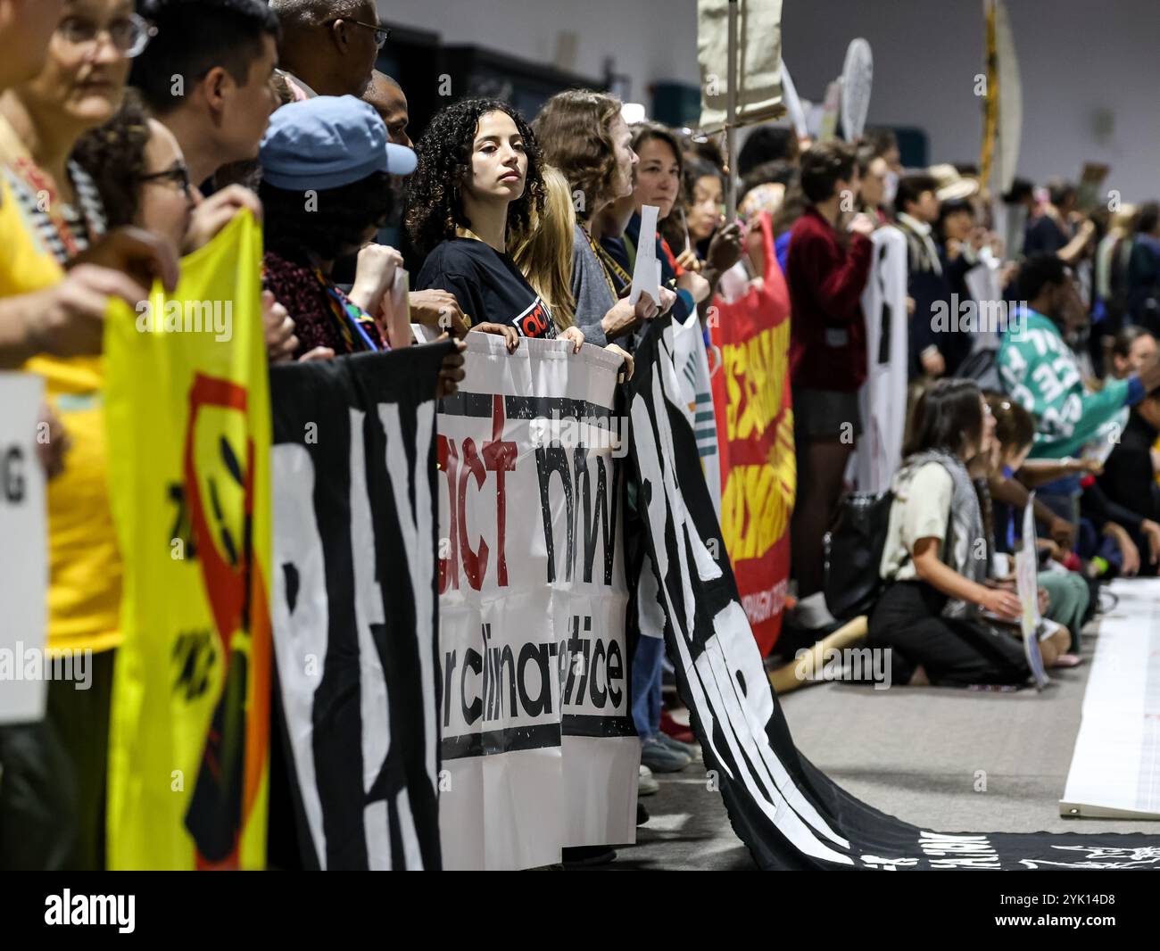 Climate activists hold a banner during a protest to influence decisions ...