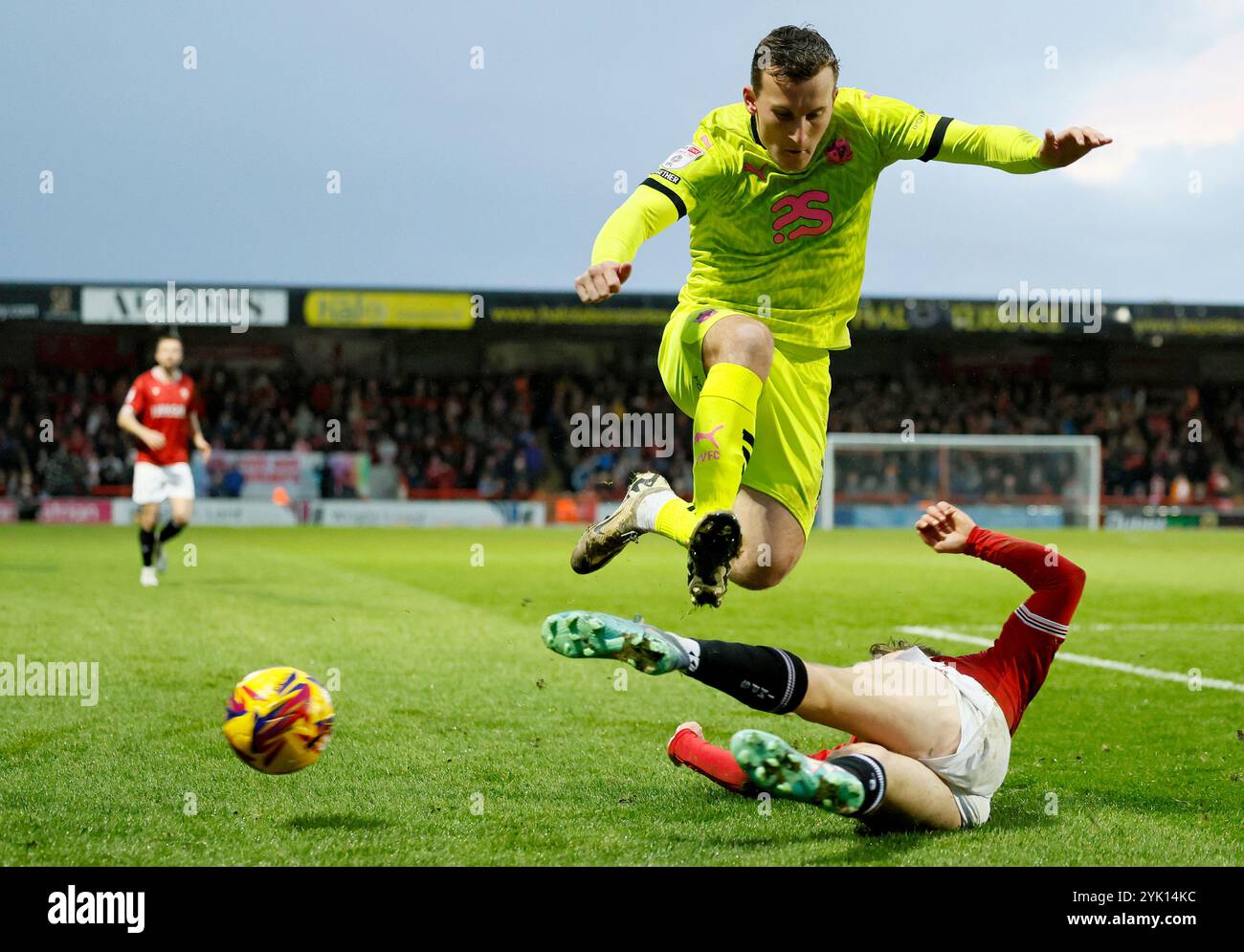 Morecambe's Tom White (bottom) tackles Port Vale's Ruari Paton during ...