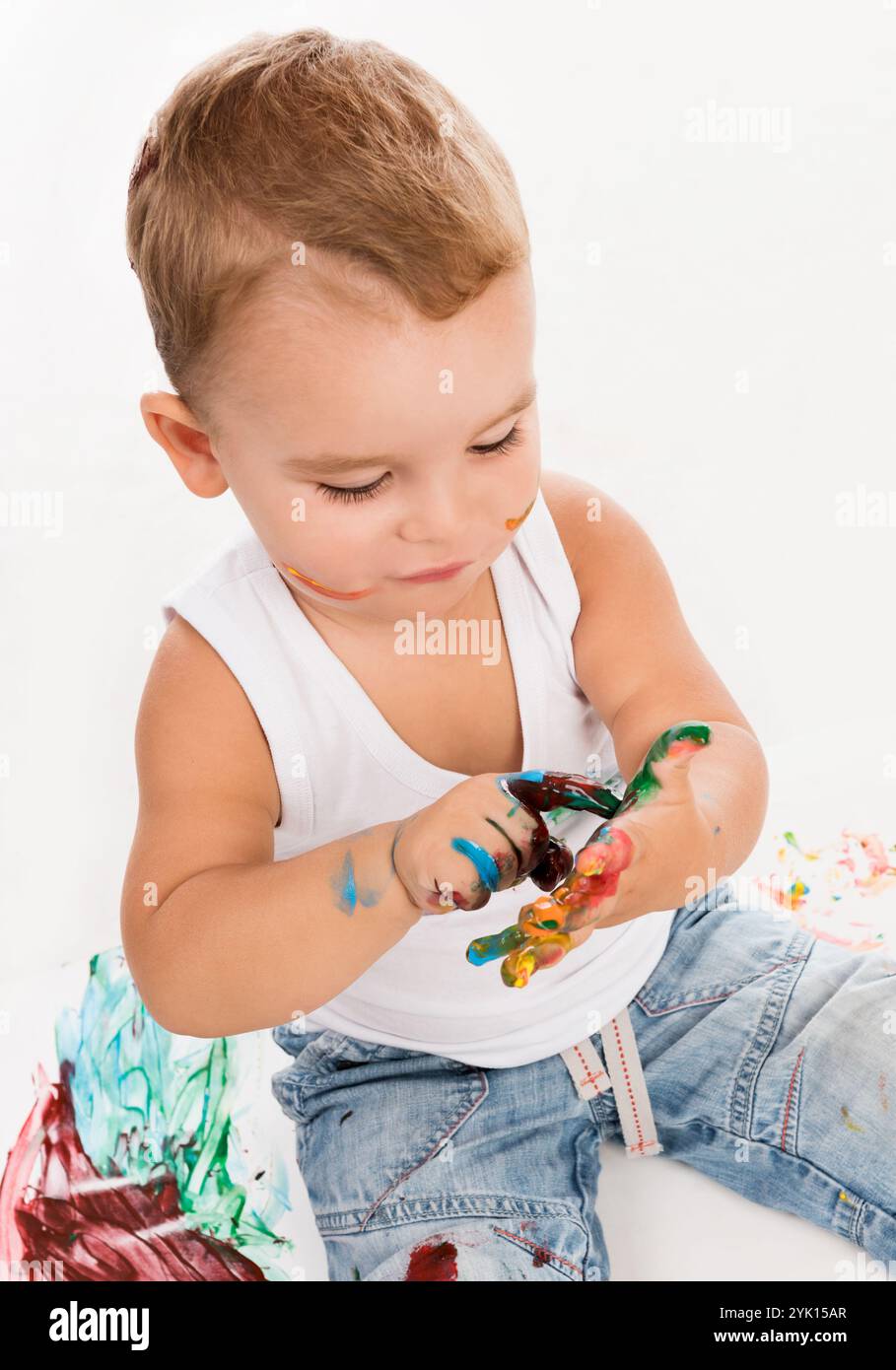 cute little boy painting his hands isolated on white background Stock ...