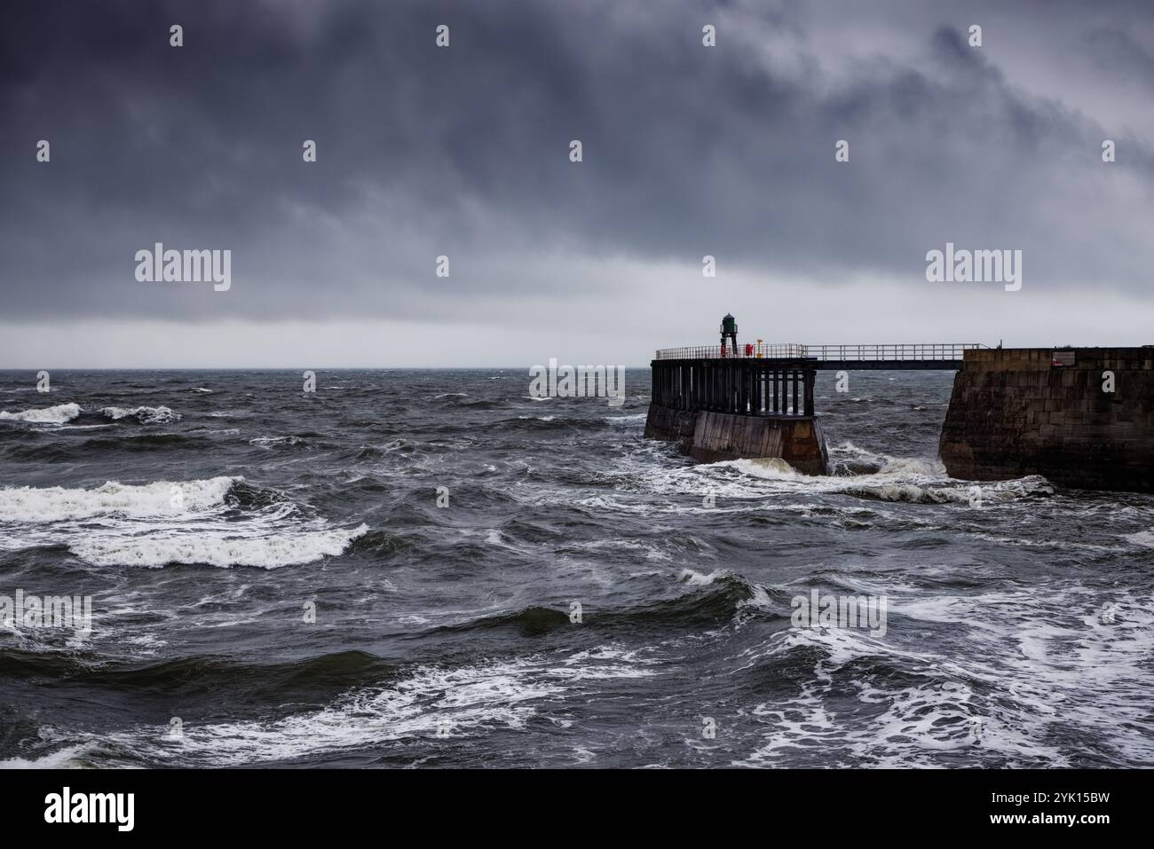Stormy seas swirl around the breakwater at Whitby Harbour, North ...