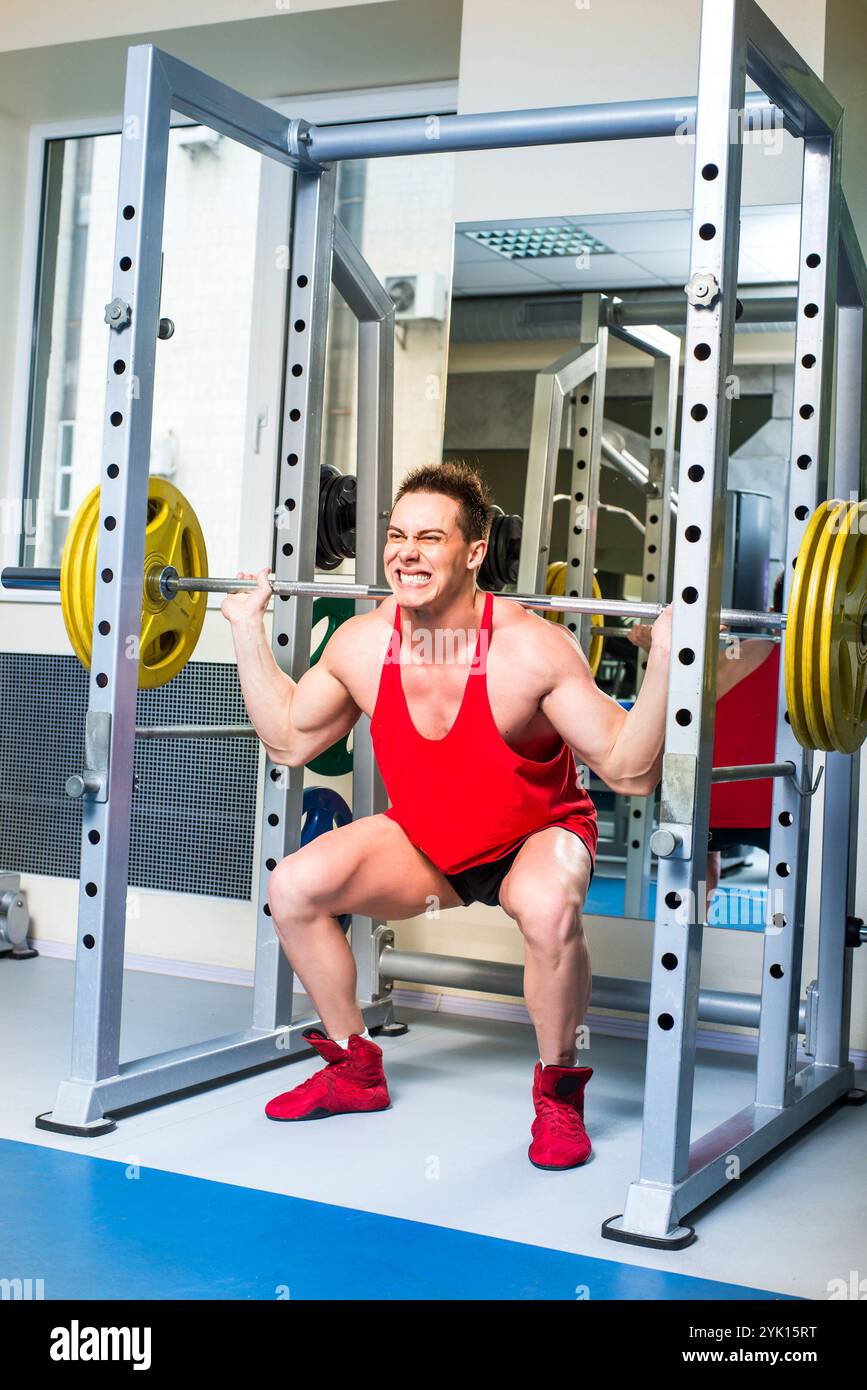 weightlifter squats with a barbell Stock Photo - Alamy