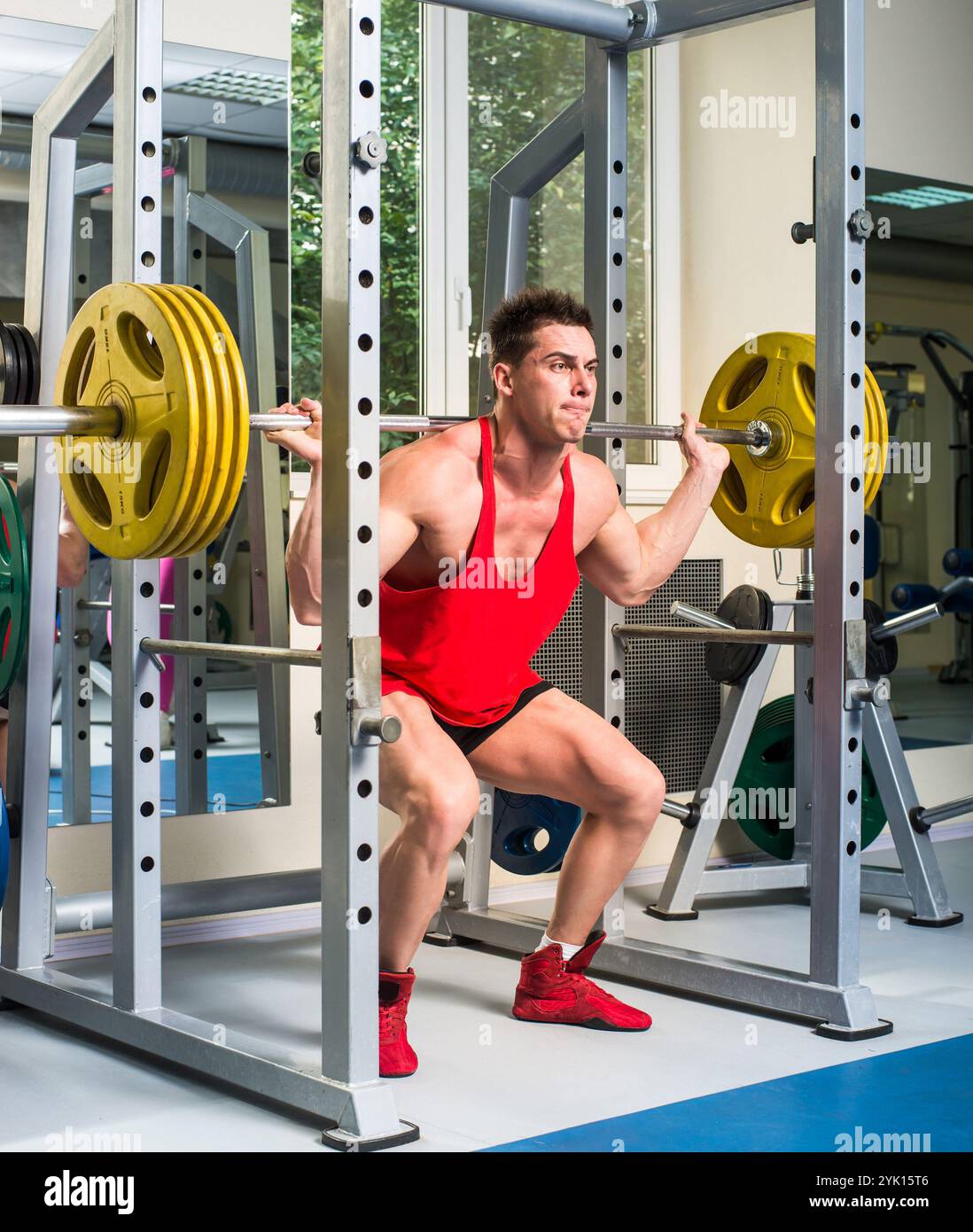 weightlifter squats with a barbell Stock Photo - Alamy