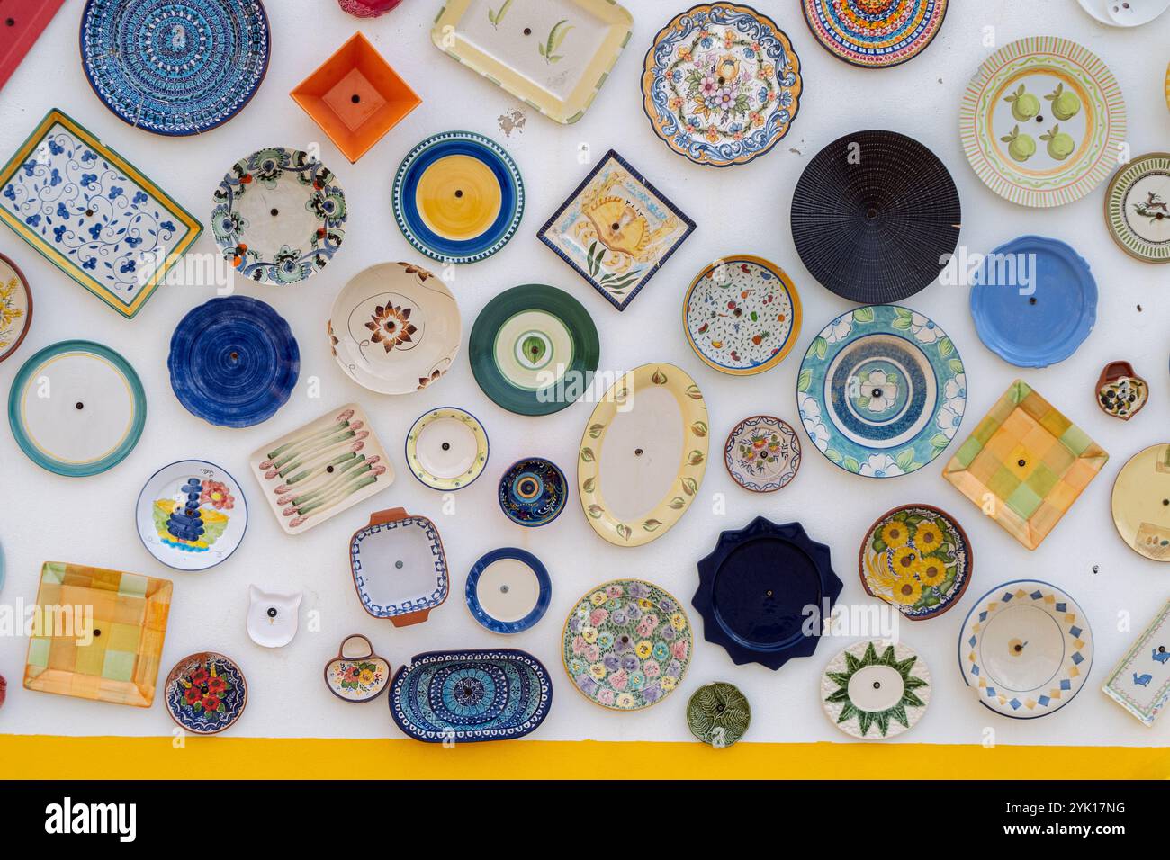 Colorful ceramic plates on white background Stock Photo - Alamy