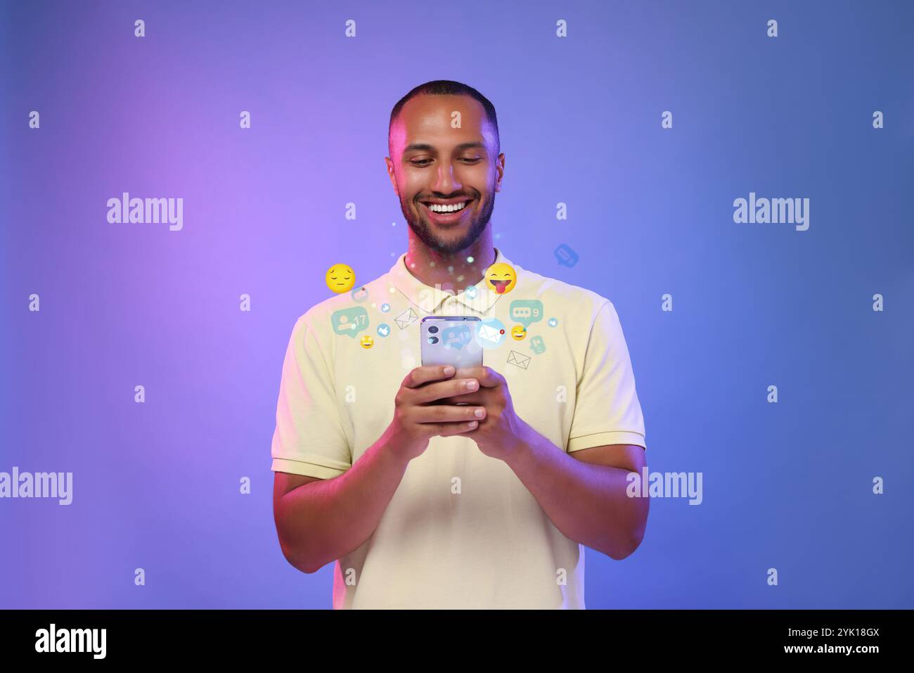 Happy man using mobile phone on color background. New message sign and ...