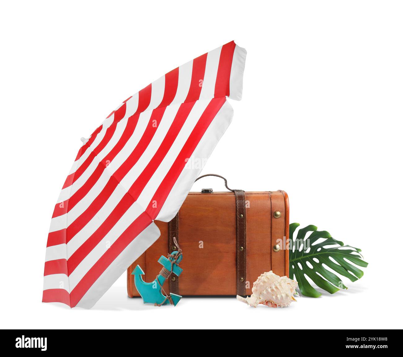 Brown travel suitcase, tropical leaf, seashell, beach umbrella and toy ...