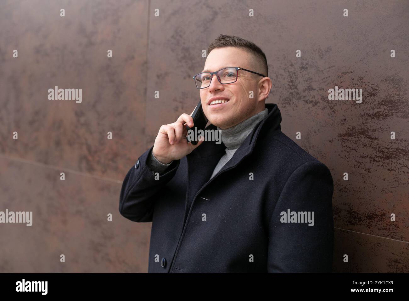 Portrait of handsome well built man smiling staying and talking on his ...