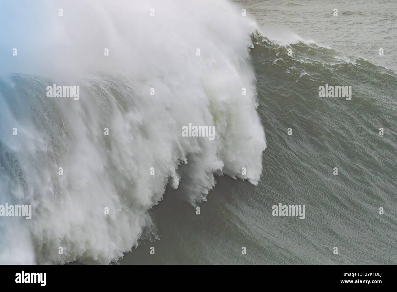 A colossal wave crashing with immense power and spray in Nazare ...