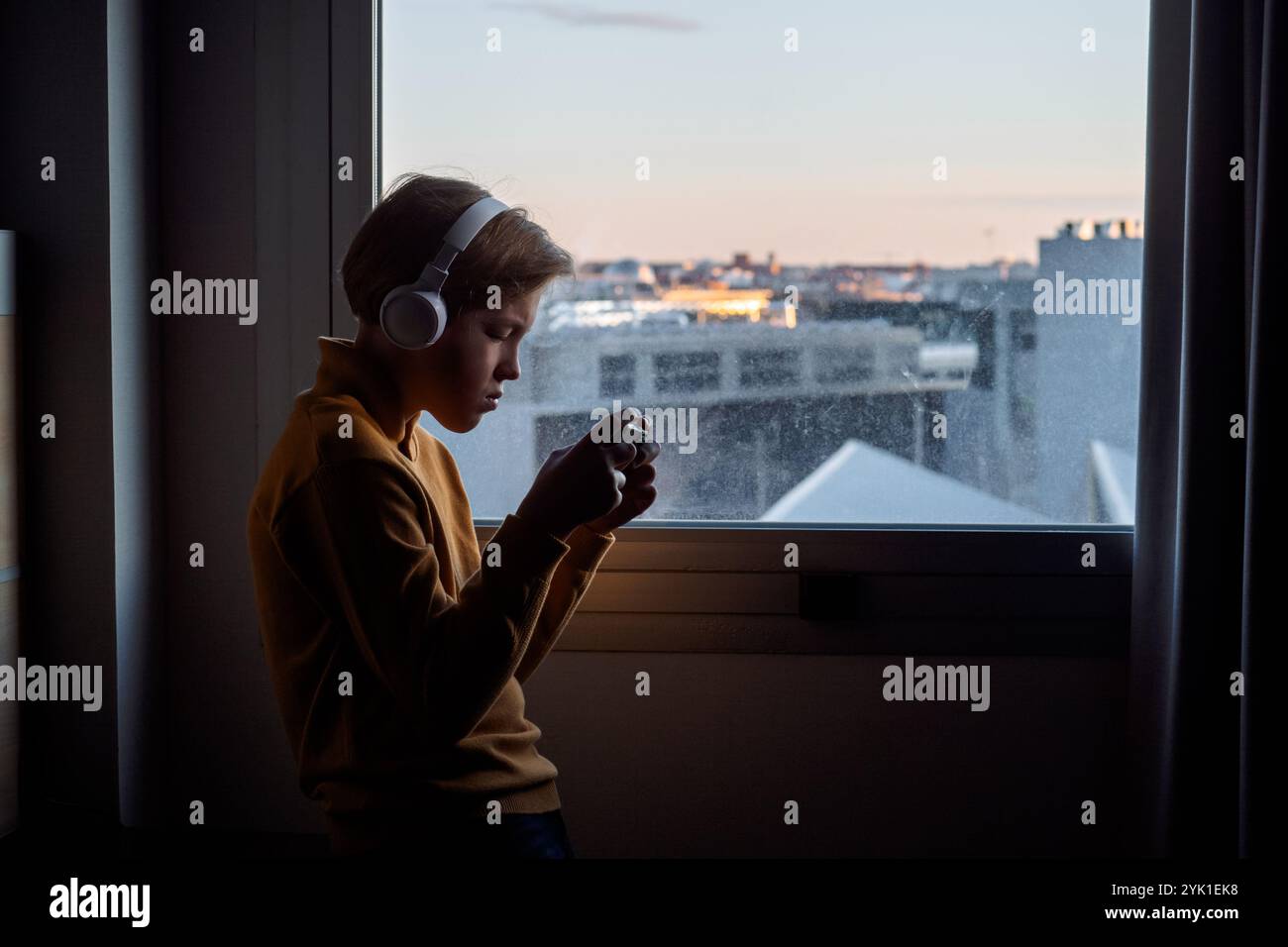 Teen boy gaming with headphones Stock Photo - Alamy