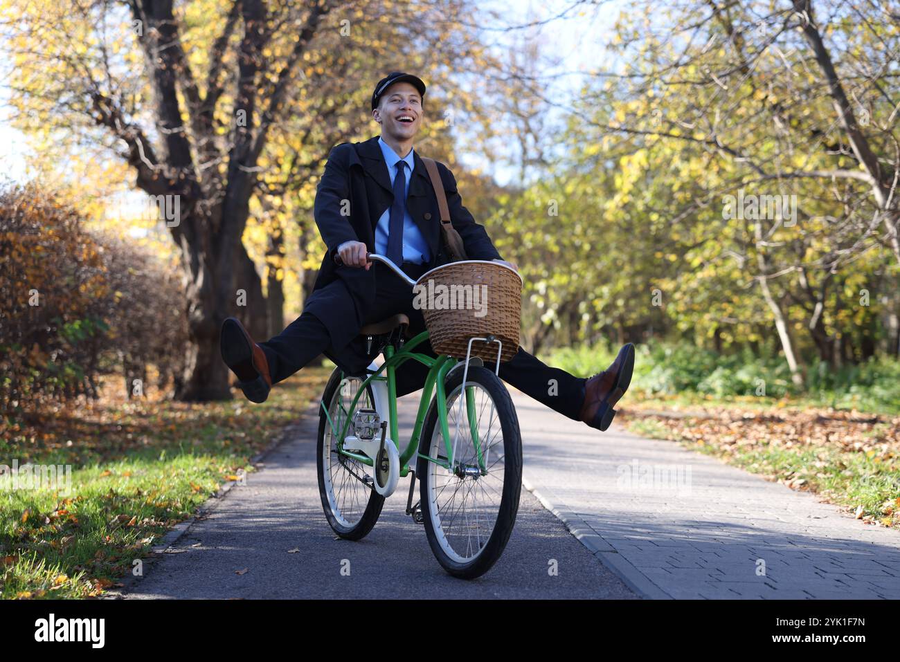 Happy mailman on bicycle outdoors. Postal service Stock Photo - Alamy