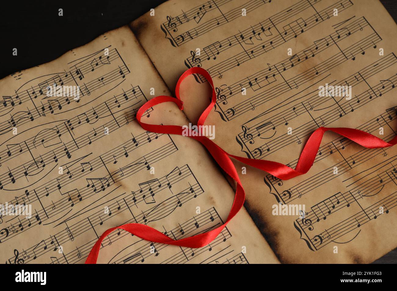 Heart shaped ribbon on musical notes, closeup Stock Photo - Alamy