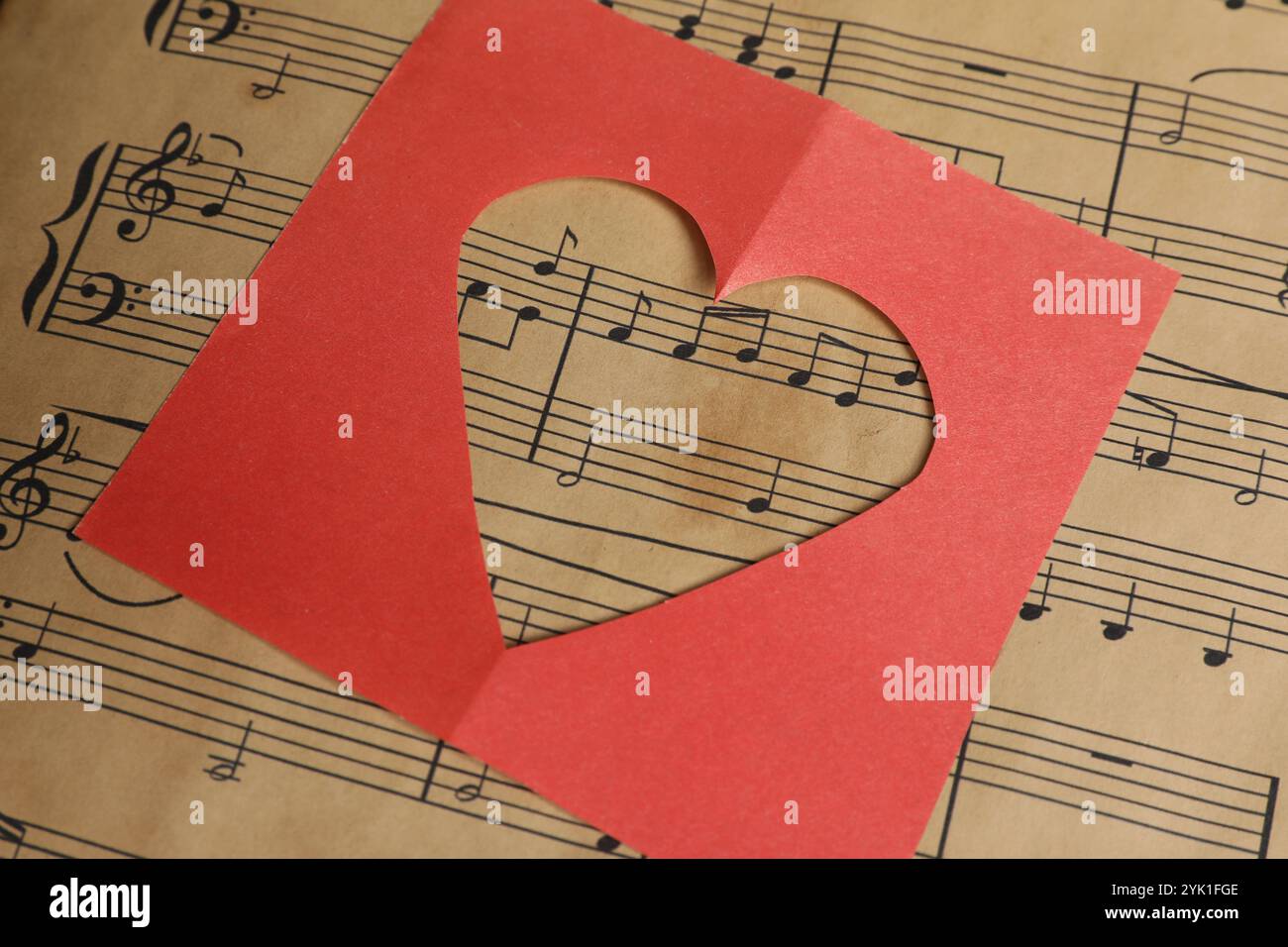 Heart shaped cutout on musical notes, closeup Stock Photo - Alamy