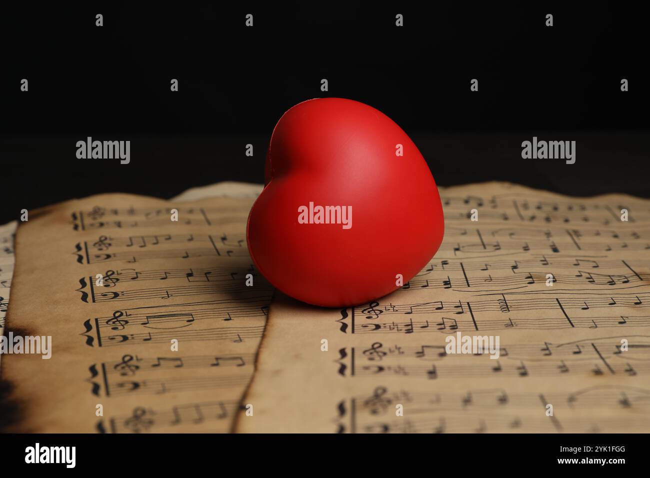 Heart figure and musical notes on black background, closeup Stock Photo ...
