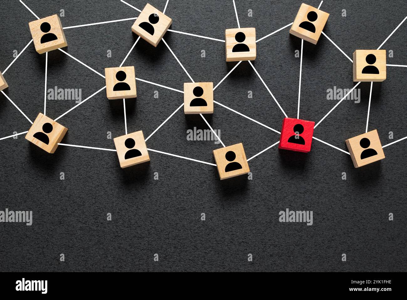 Wooden blocks connected together on a black background Stock Photo - Alamy