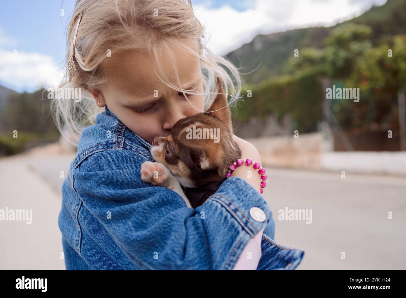 Child hugging puppy with affection Stock Photo - Alamy