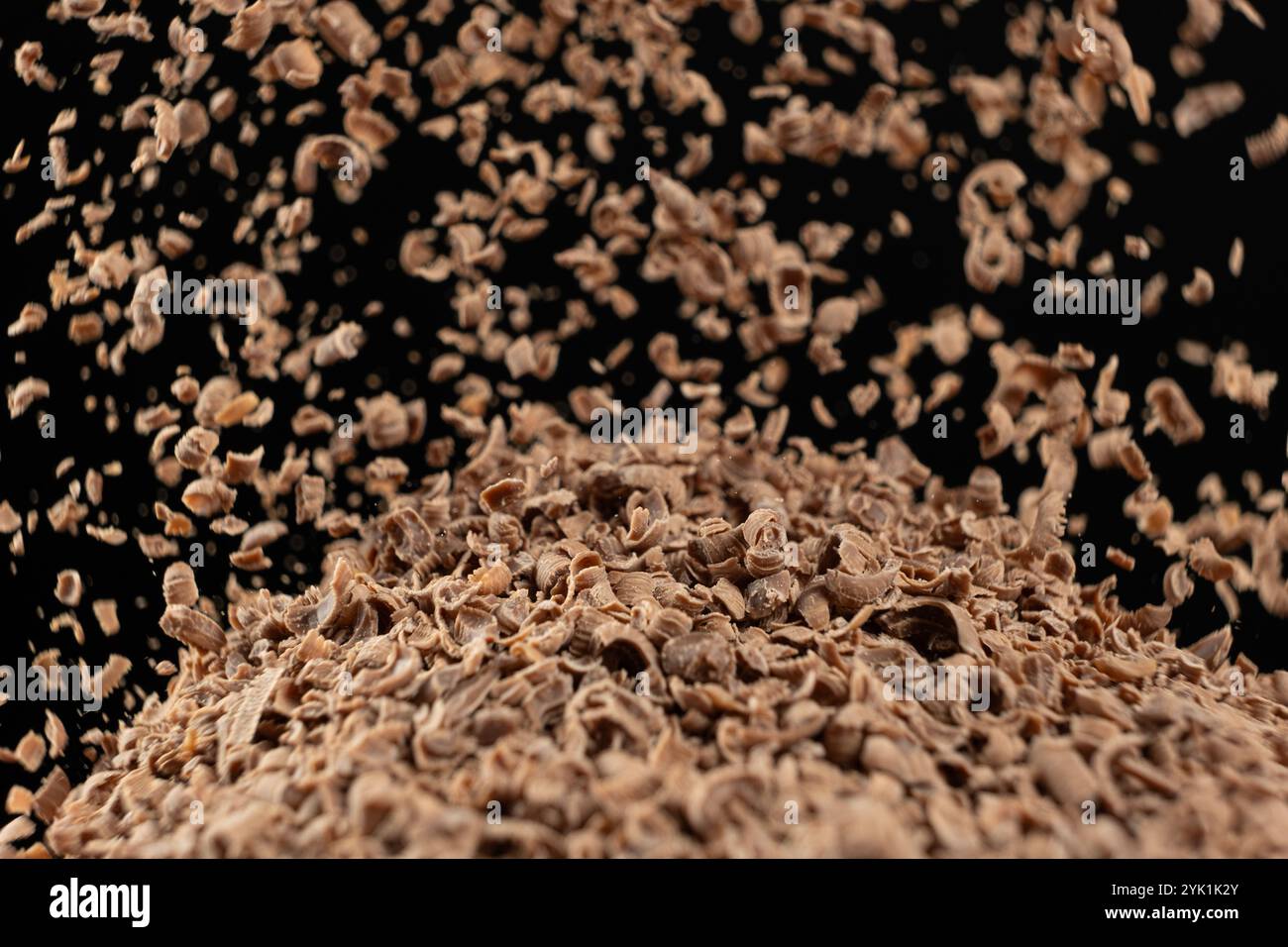 Shredded natural organic chocolate pour on black background Stock Photo ...
