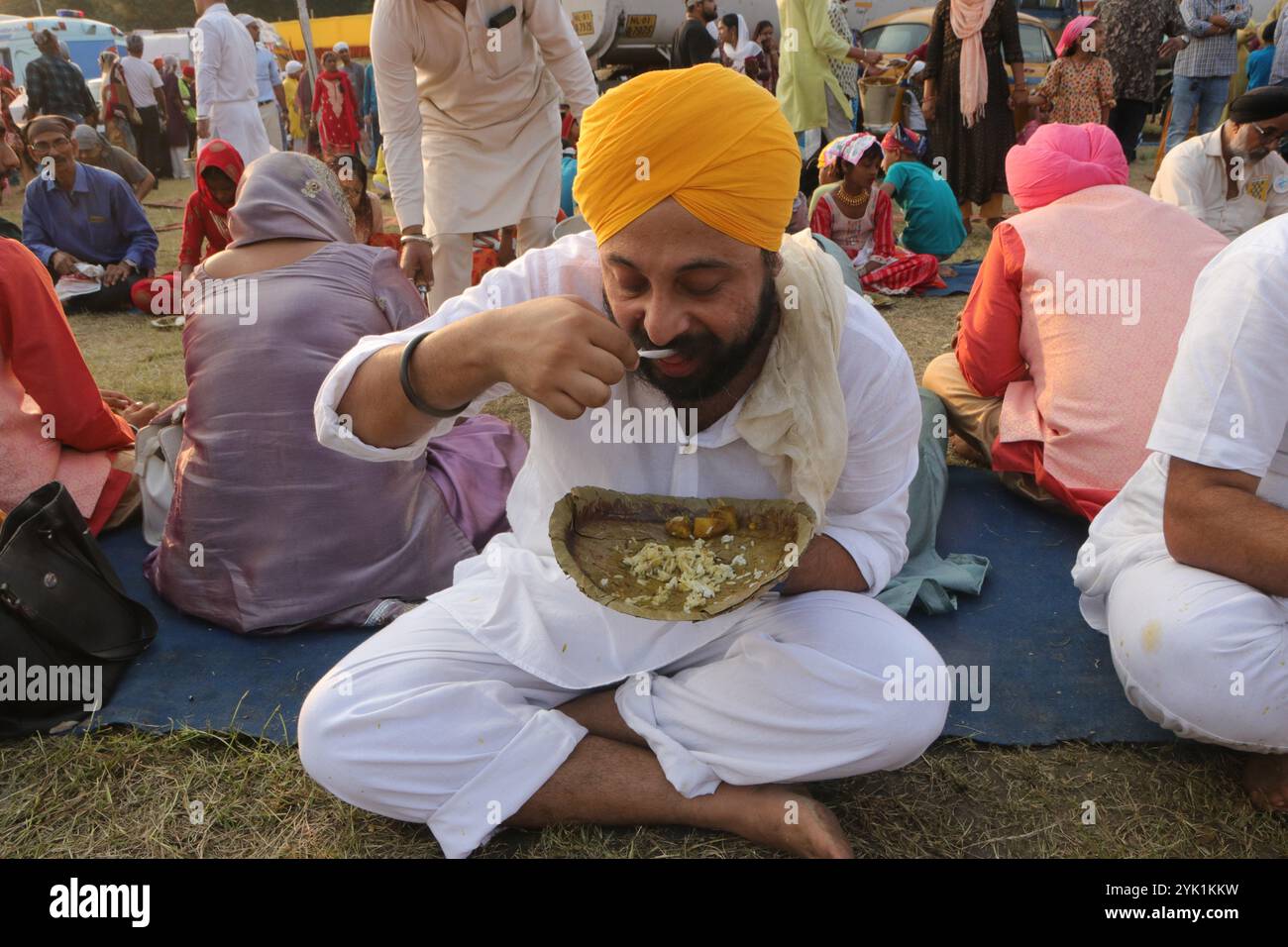 Non Exclusive: A Devotee eating on the occasion of the birth ...