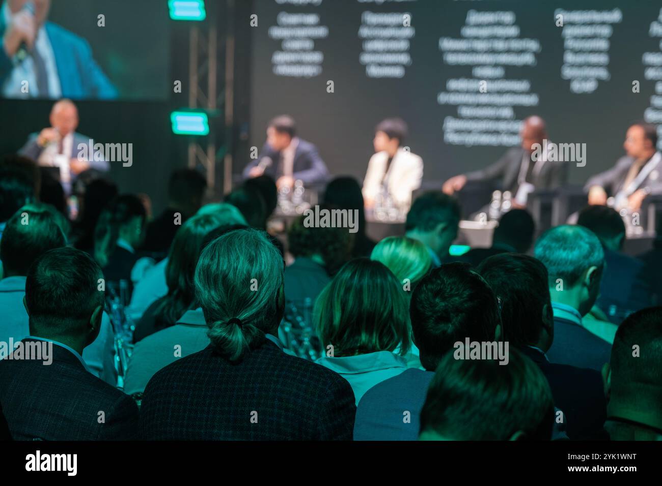 Audience attending business conference panel discussion with ...