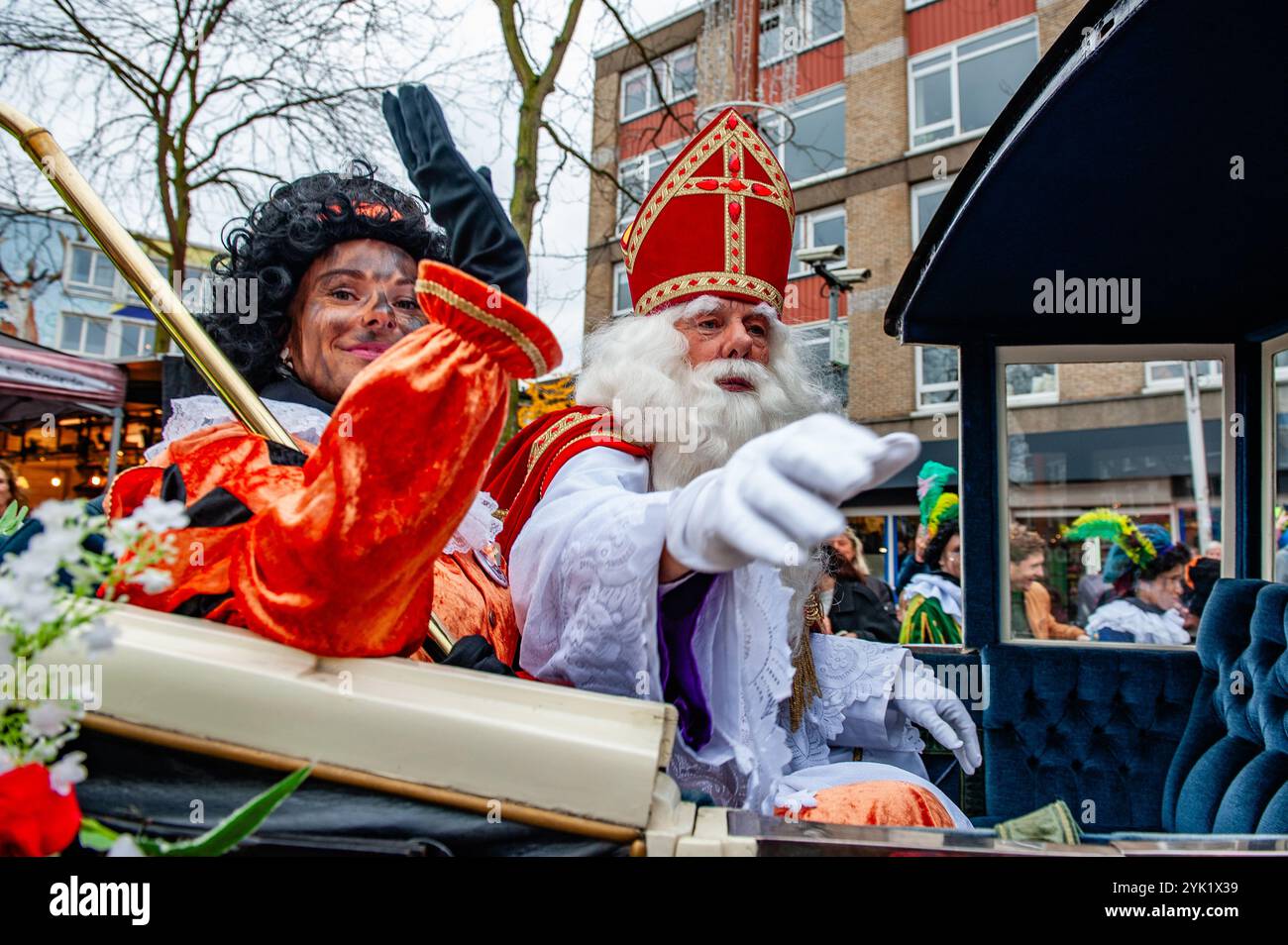 St. Nicholas and his helper are seen greeting the audience. On the ...