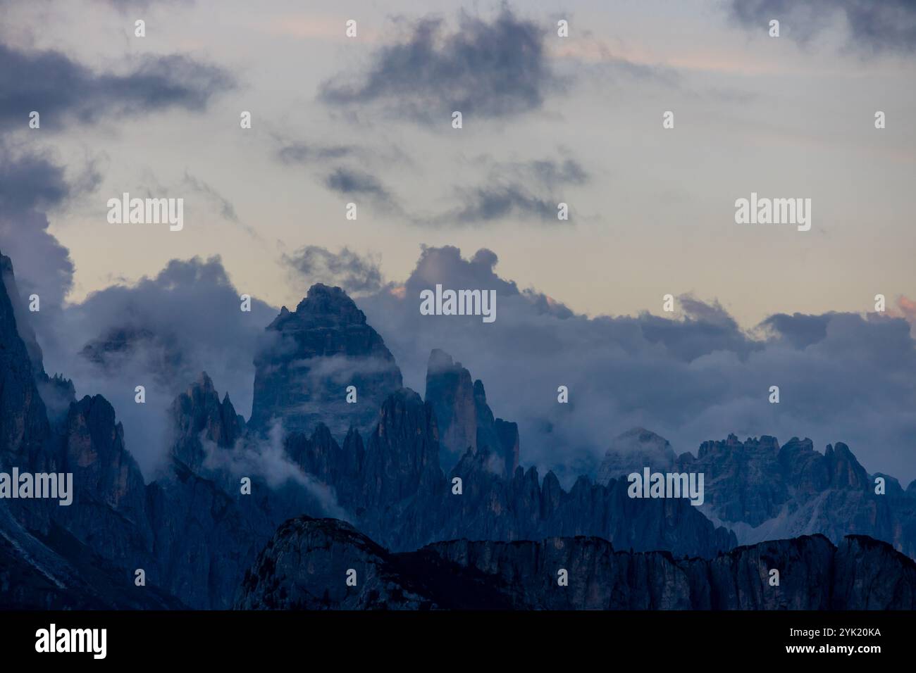 Mountains above the clouds stunning landscape. High rocky peaks rising ...