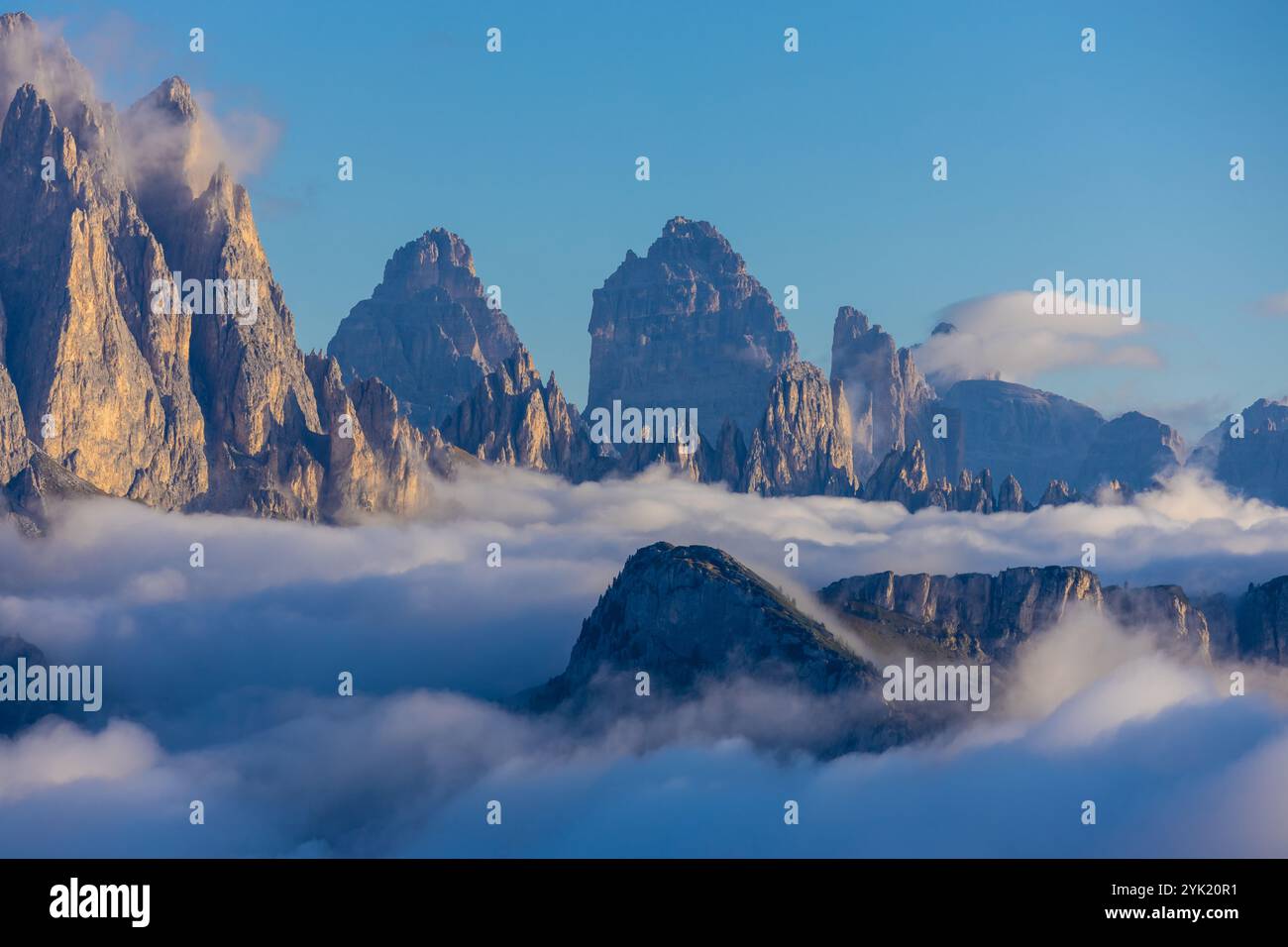 Mountains above the clouds stunning landscape. High rocky peaks rising ...