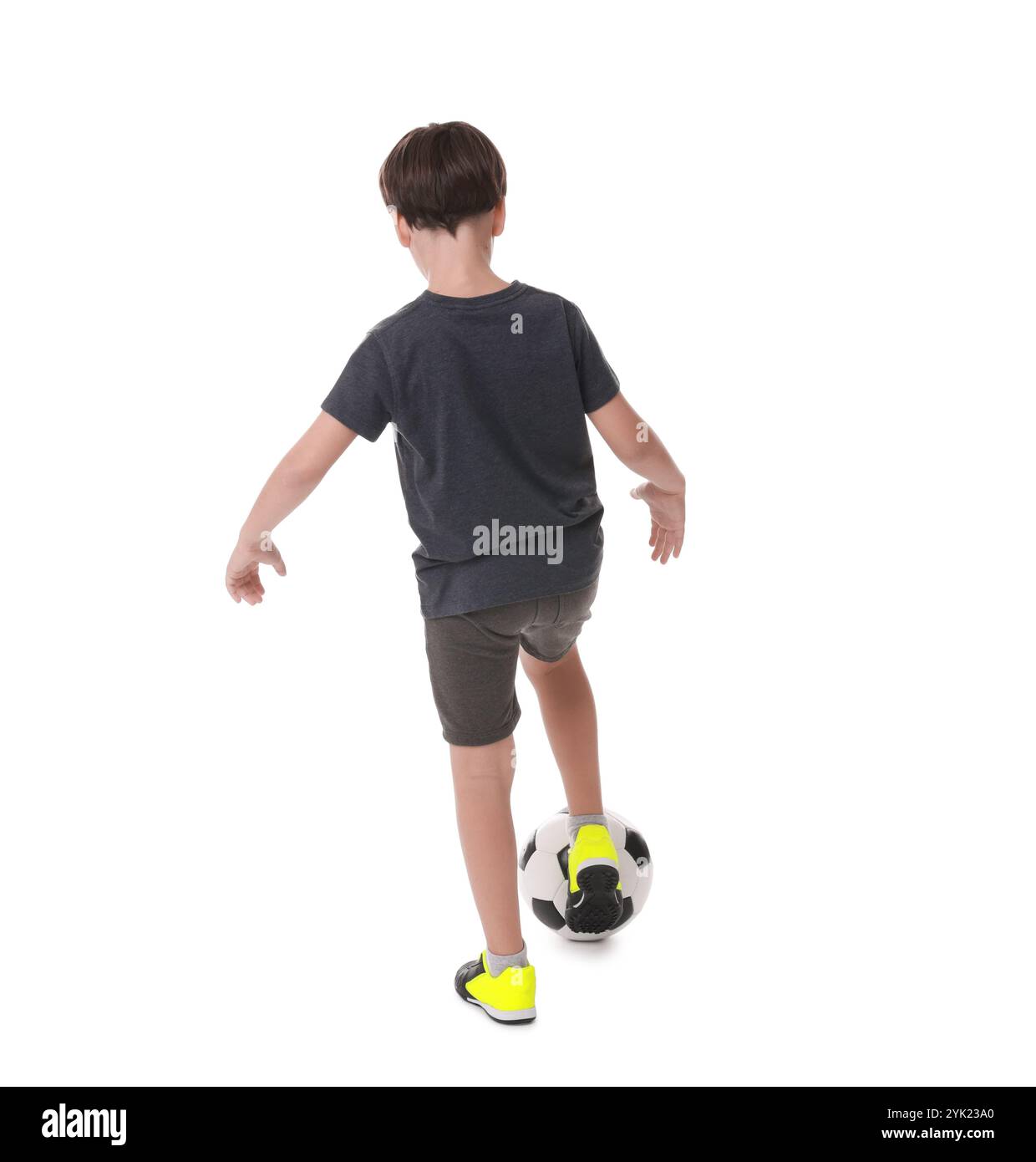 Boy with soccer ball playing football on white background, back view ...