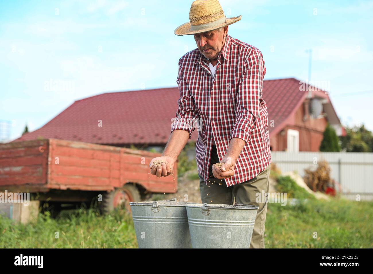 Man with buckets hi-res stock photography and images - Alamy