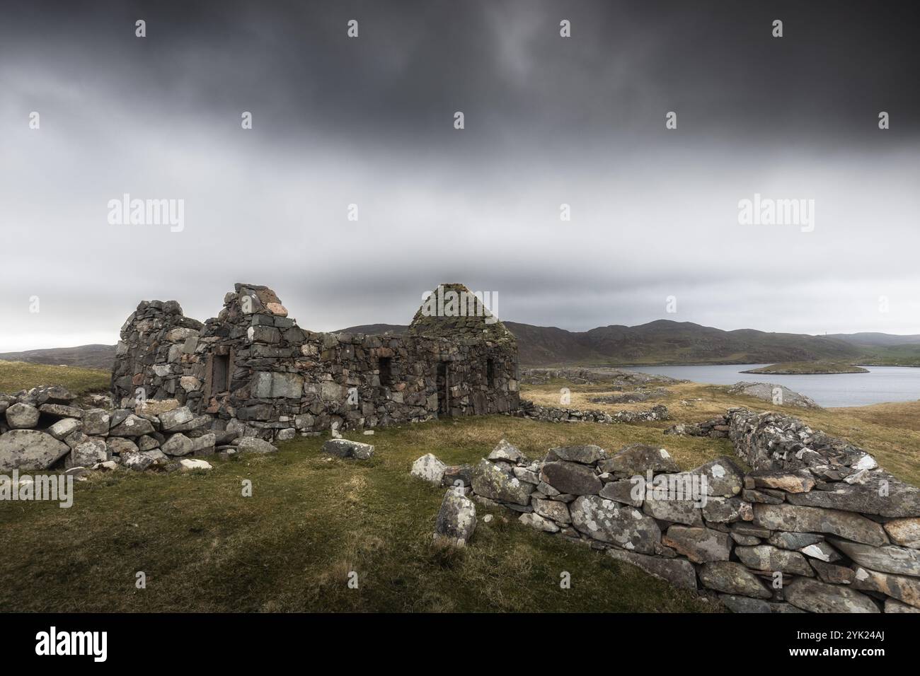 A dilapidated cottage with remains of walls stands in a lonely ...