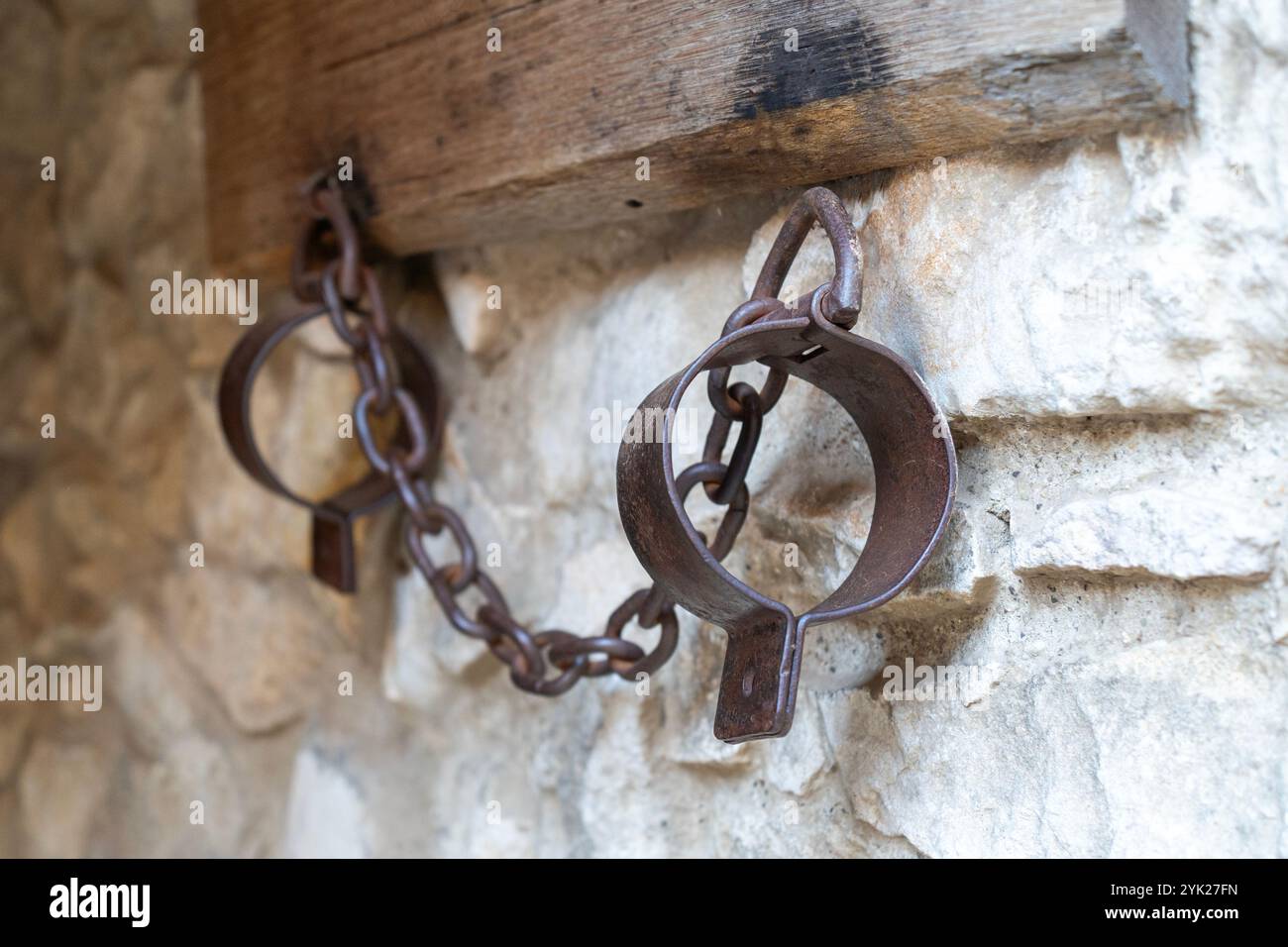 Medieval patinaed handcuffs on the stone wall Stock Photo - Alamy