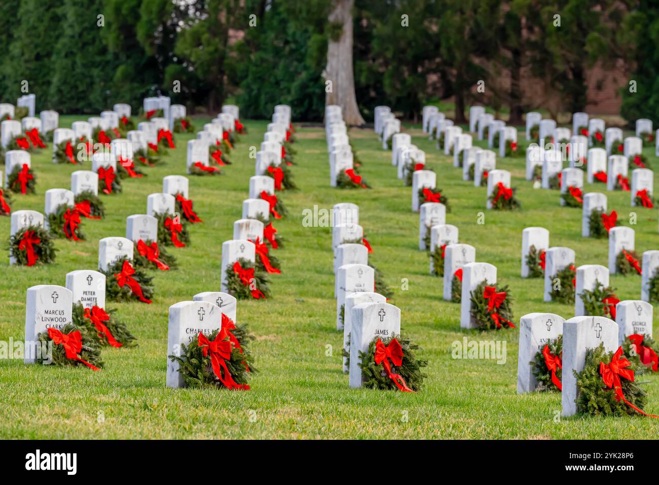 Atop a hill, a veterans cemetery with white headstones and the American ...