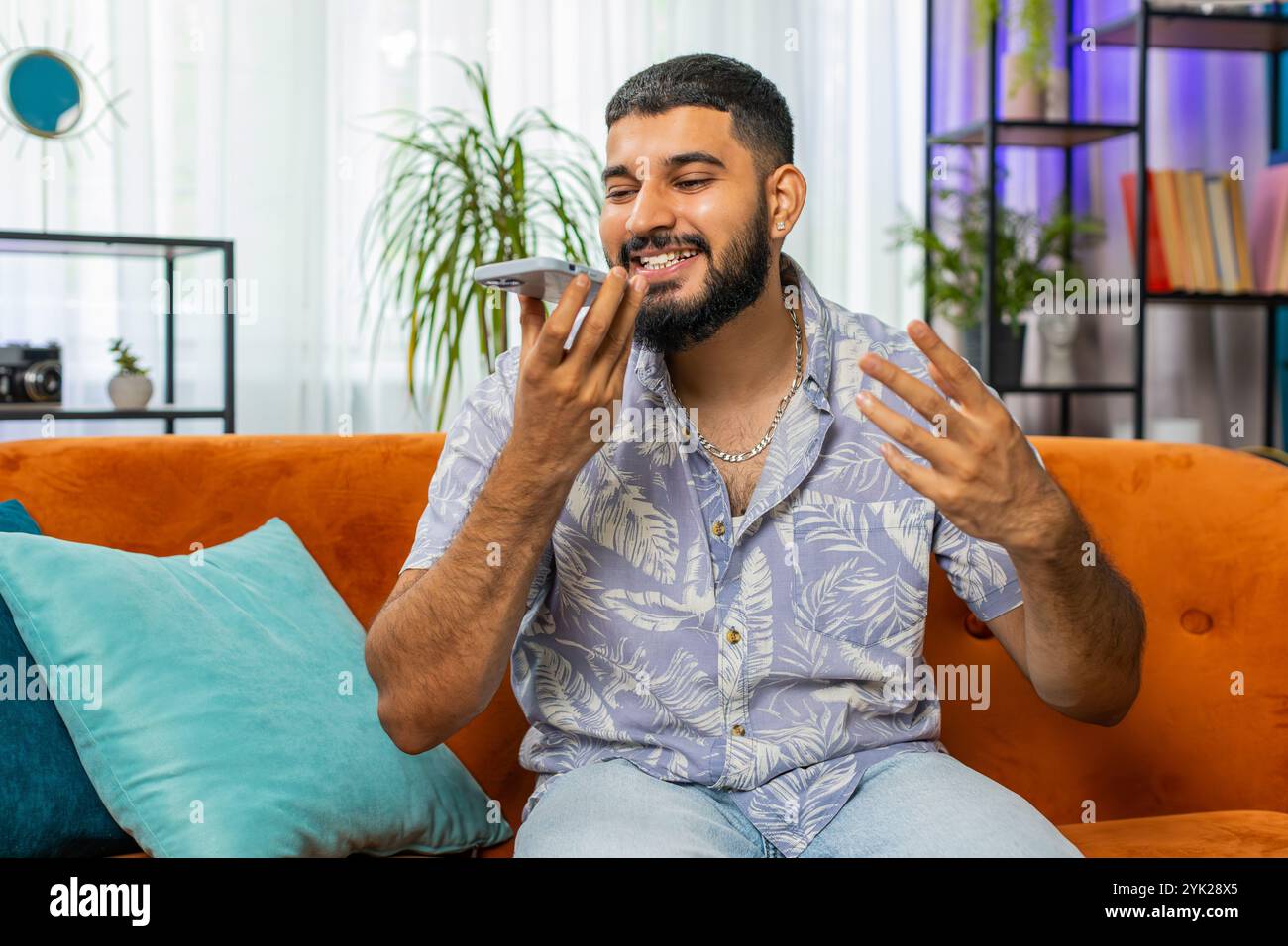Happy excited Indian man making phone call conversation with friends at ...